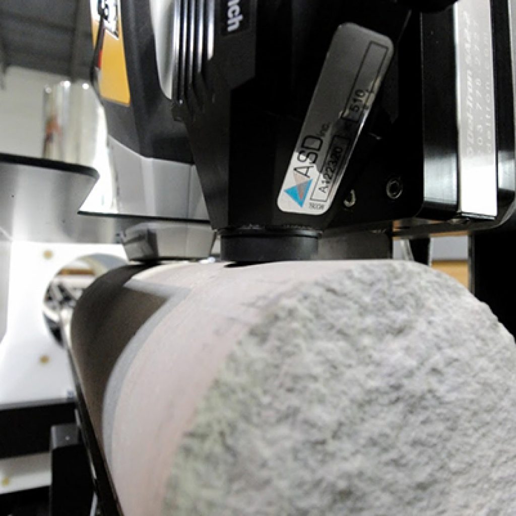 The ASD TerraSpec 4 making a measurement on a rock core in the Geotek ...